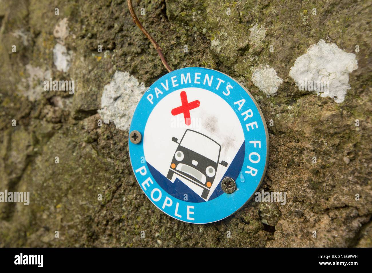 A small sign deterring motorists from parking on the pavement. England ...