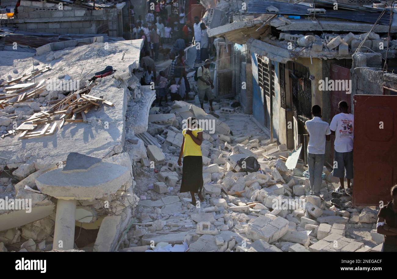 A woman walks among debris in Port-au-Prince, Thursday, Jan. 14, 2010 ...