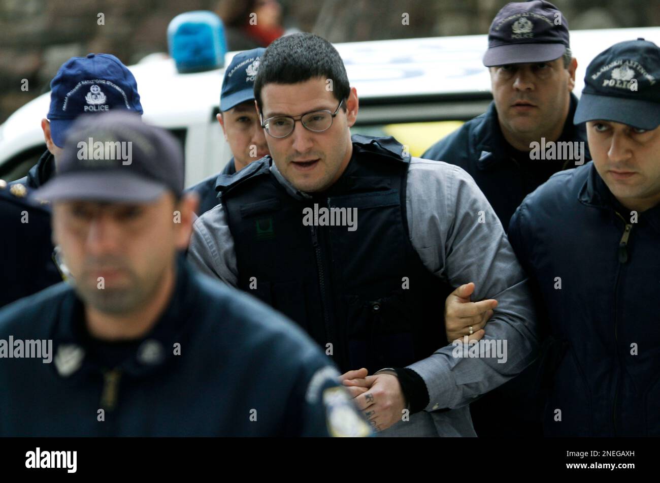 Greek Police escort murder suspect Marios Antonopoulos into a ...