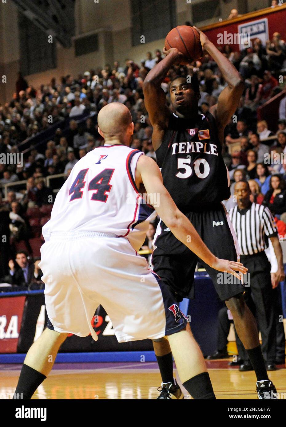 Temple center Micheal Eric (50) shoots over Penn forward Conor Turley ...