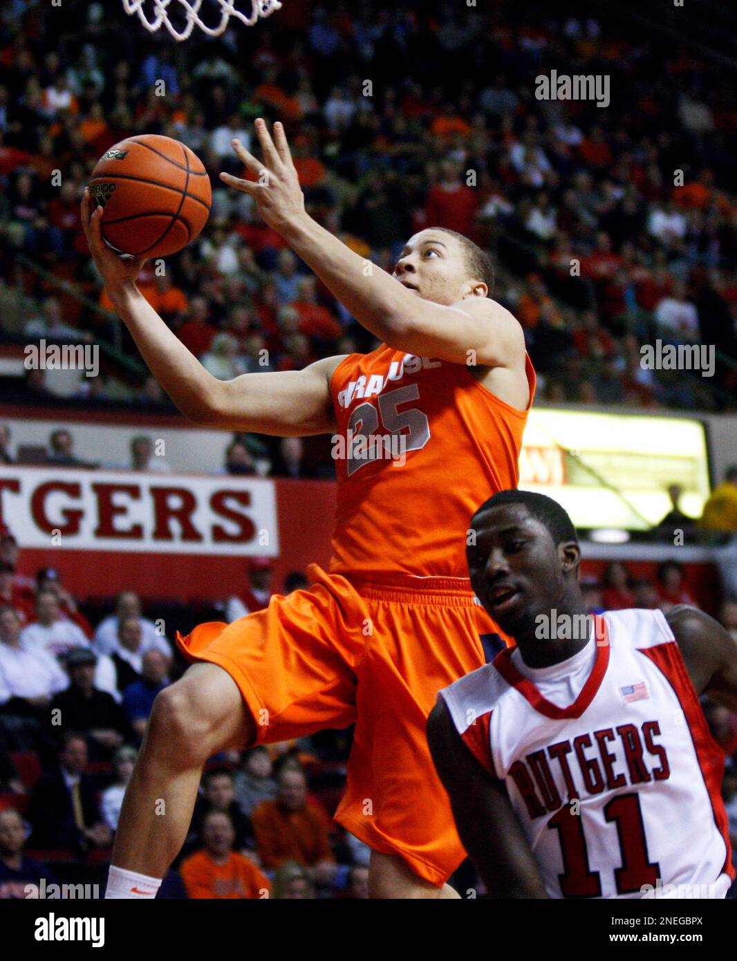 Syracuse's Brandon Triche (25) takes a shot past Rutgers' Dane Miller ...
