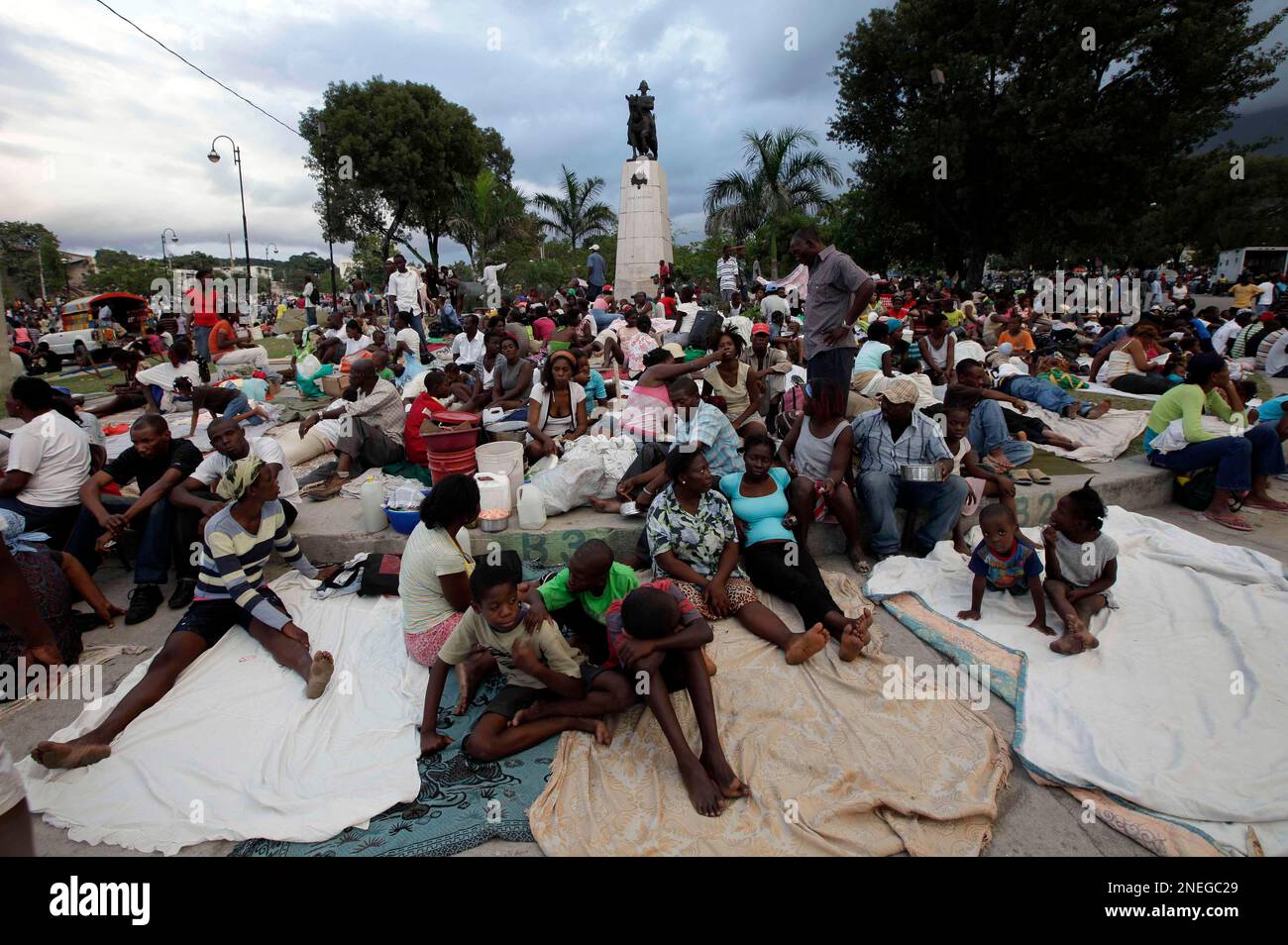 People sit at a park a day after the destructive earthquake in downtown ...