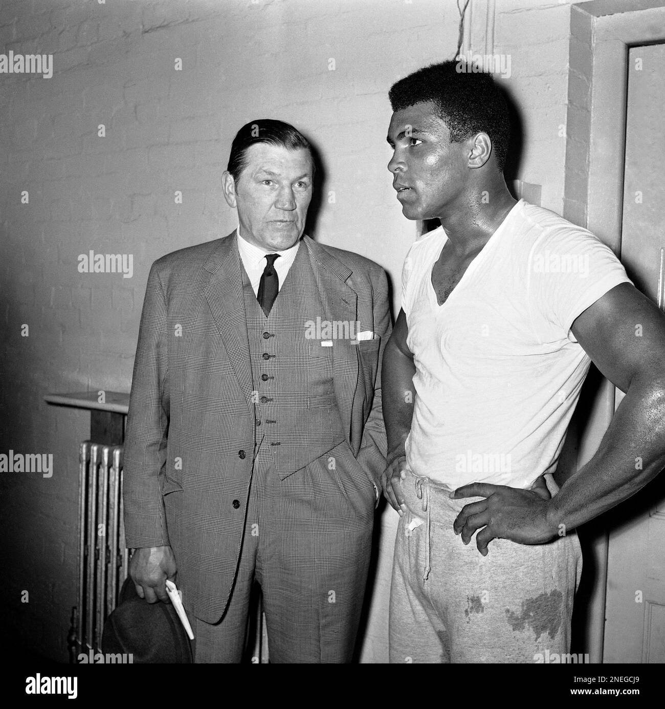 World heavyweight boxing champion Muhammad Ali, his face glistening ...