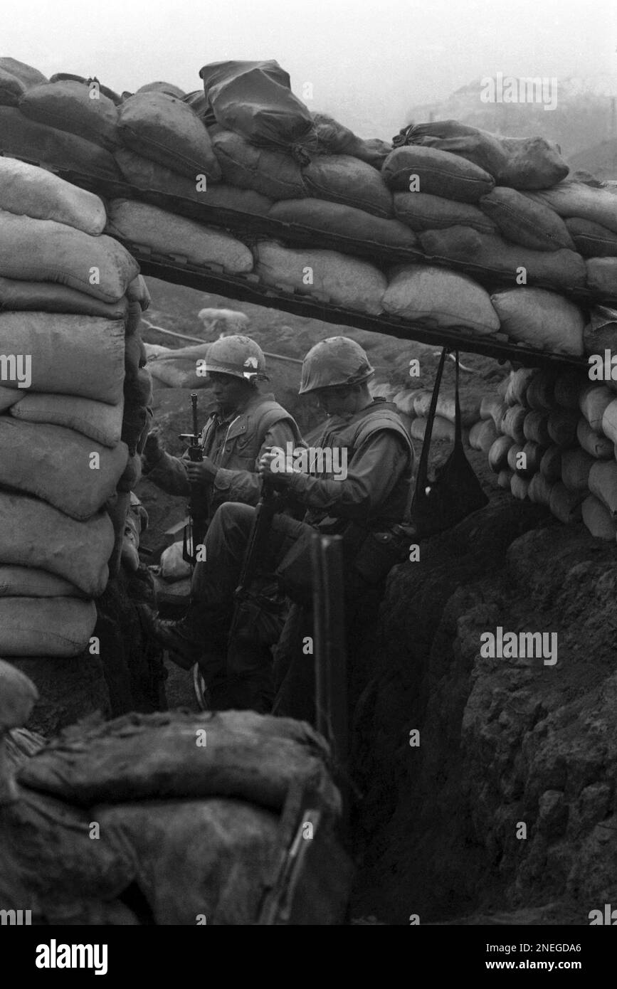 Sandbags surround two leathernecks dug into position at the U.S. Marine ...