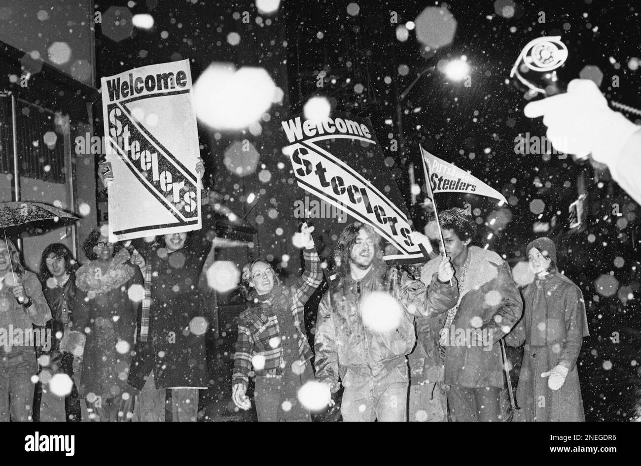Pittsburgh Steeler fans march through downtown Pittsburgh waving ...