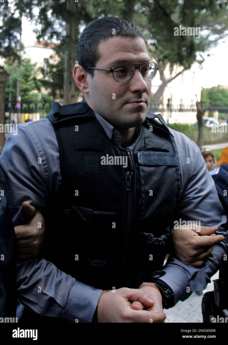 Greek Police escort murder suspect Marios Antonopoulos into a ...