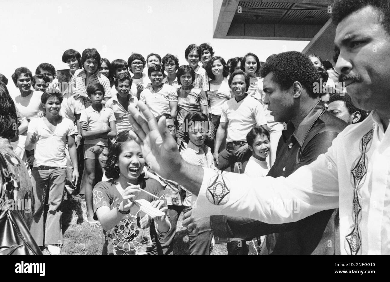 A girl thrusts a pen and paper toward Muhammad Ali on Sept. 25, 1975 as ...