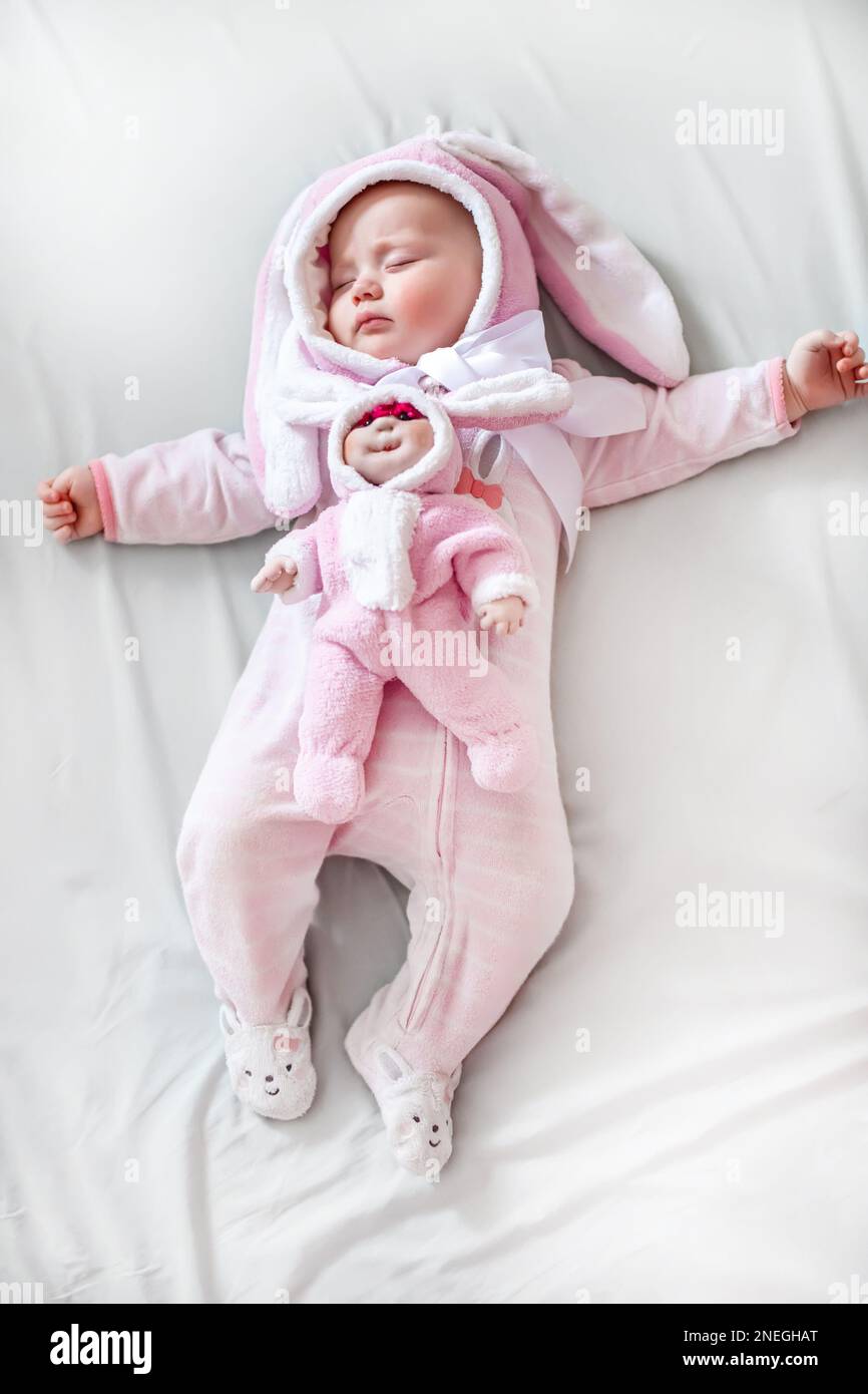 Funny baby sleeping on bed at home. Child daytime bottom up sleeping ...