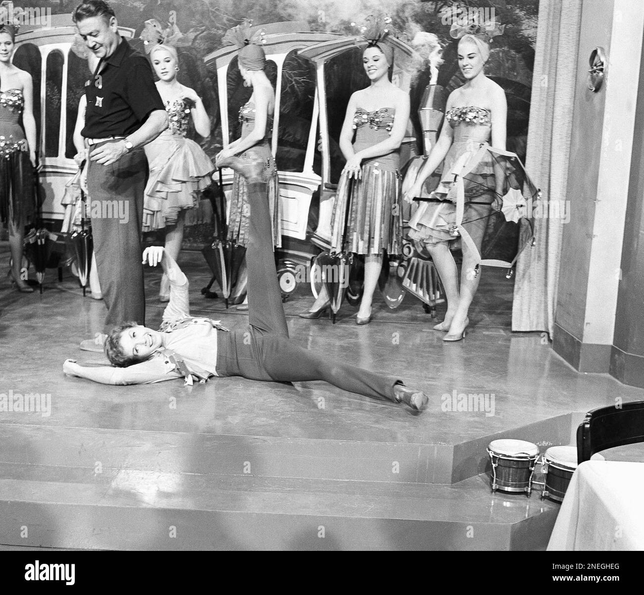 Debbie Reynolds exercises her leg between scenes for a new film, ?Say ...