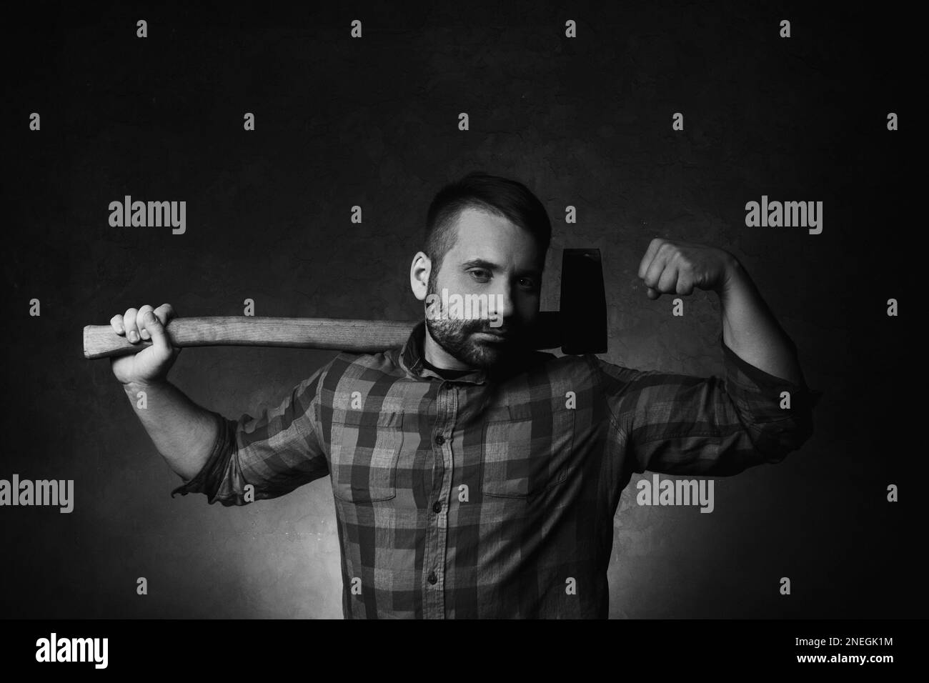Strong woodsman with axe. Male strength Stock Photo - Alamy