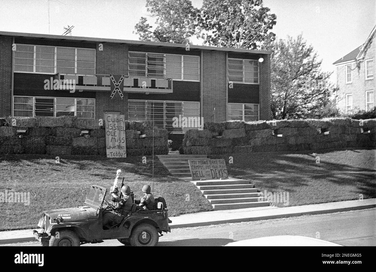 A jeep patrol passes a fraternity house on the campus of Ole Miss at ...