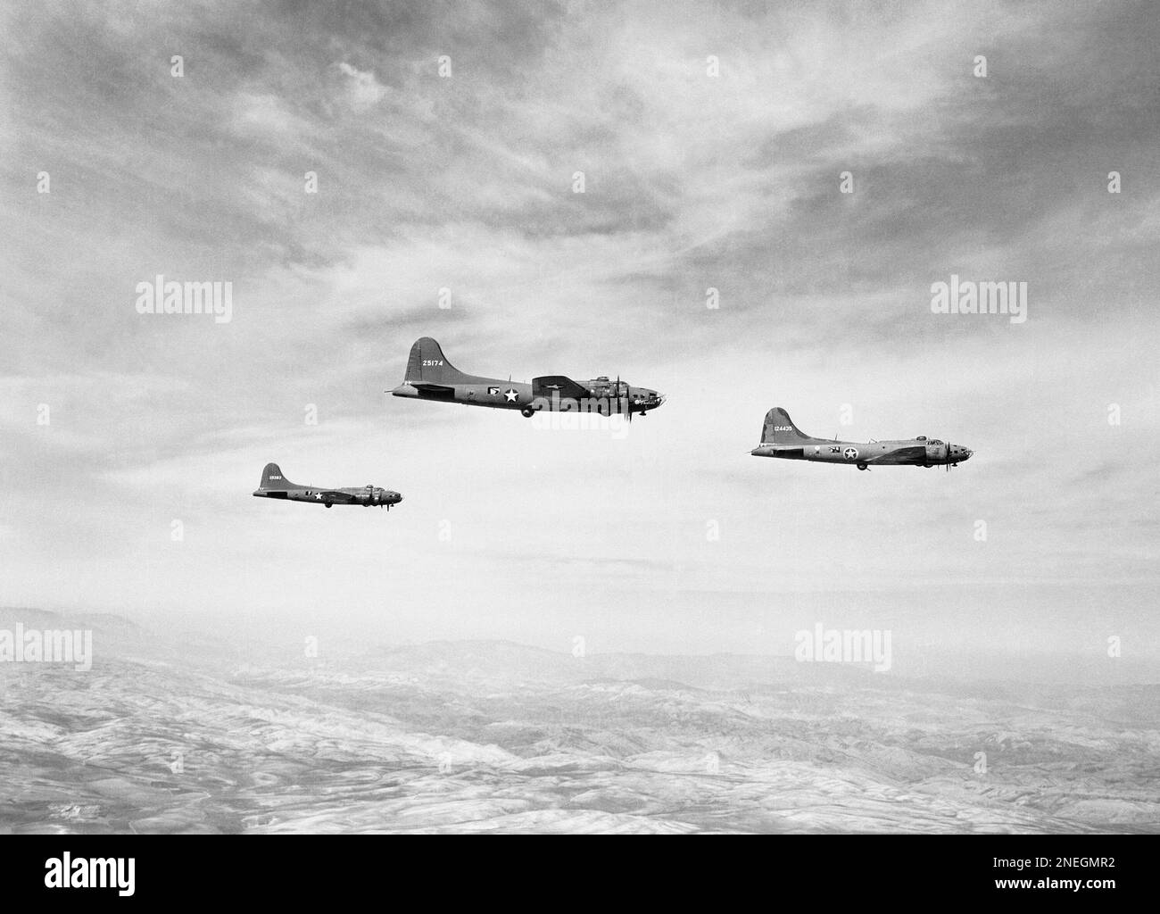 U.S. Flying Fortresses, guns sticking out in all directions, wing over ...