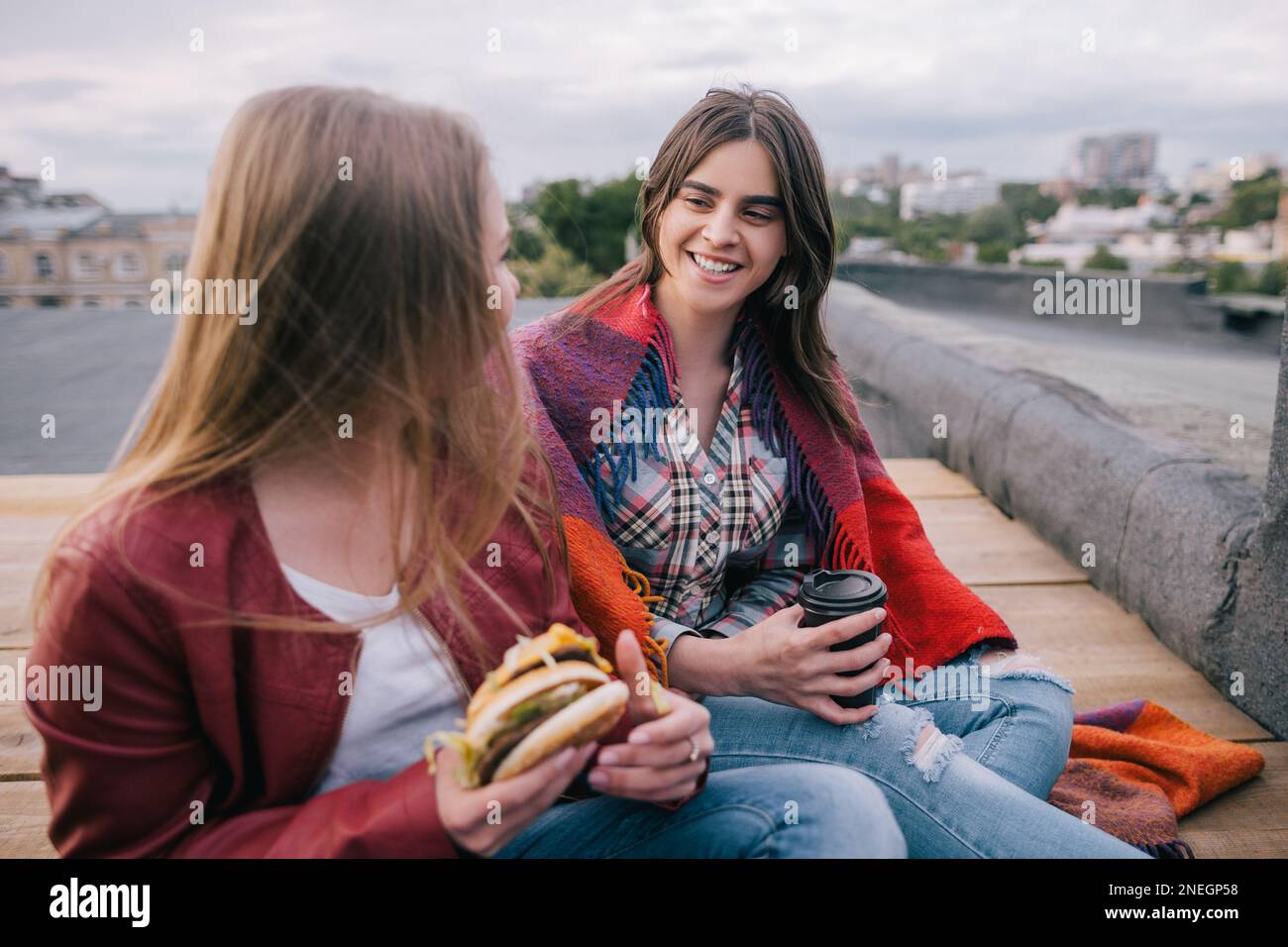 Meeting friends with takeaway junk food on roof Stock Photo - Alamy