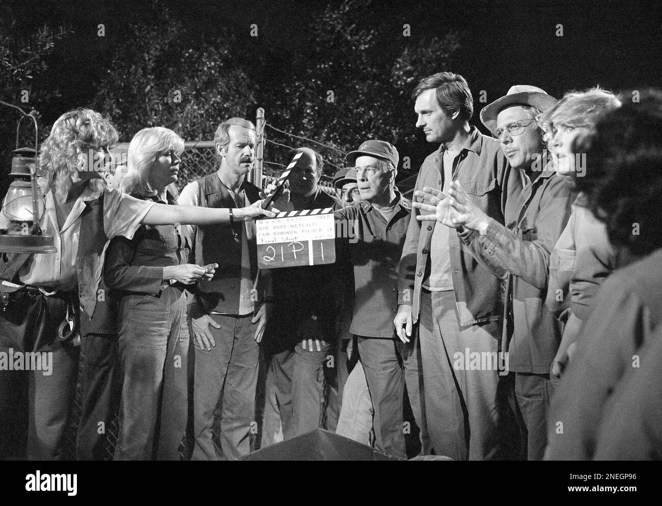 A crew member holds up a clacker as some of the actors it to begin ...