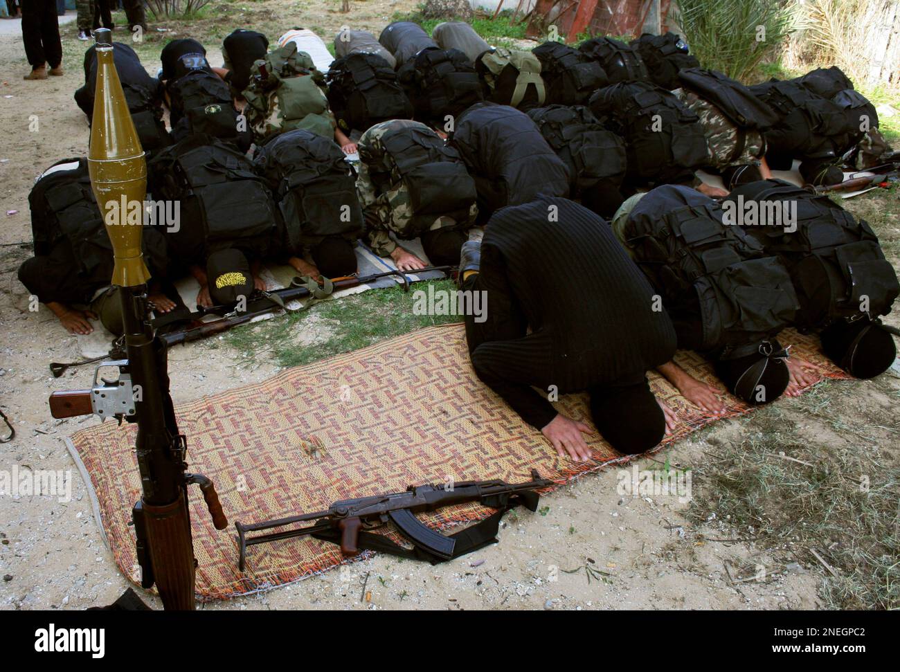 Palestinian Islamic Jihad militants pray during the funeral of Awad Abu ...