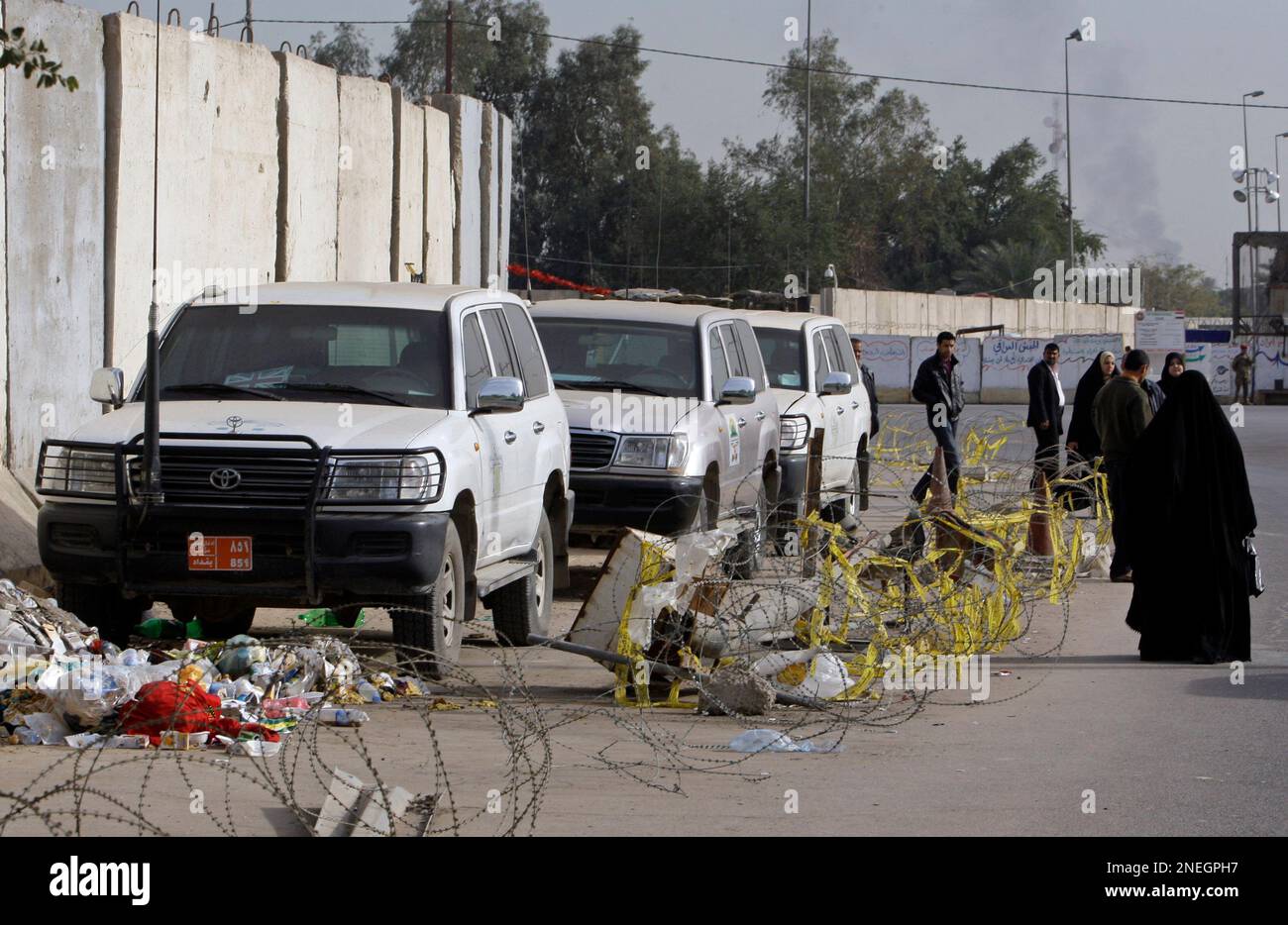 People pass by armored SUVs used by private security companies at a ...