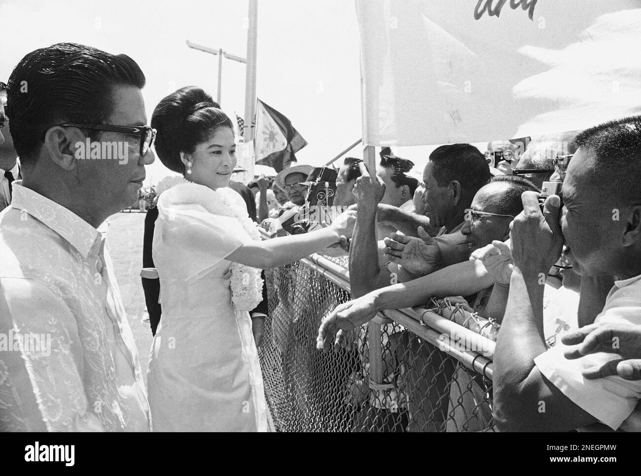 Mrs. Ferdinand Marcos, wife of the Philippine President, shakes hands ...