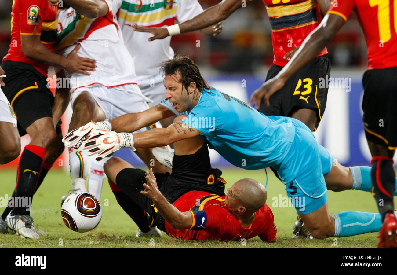 Angola's goalkeeper Carlos dives over teammate Kali, as he fails to ...