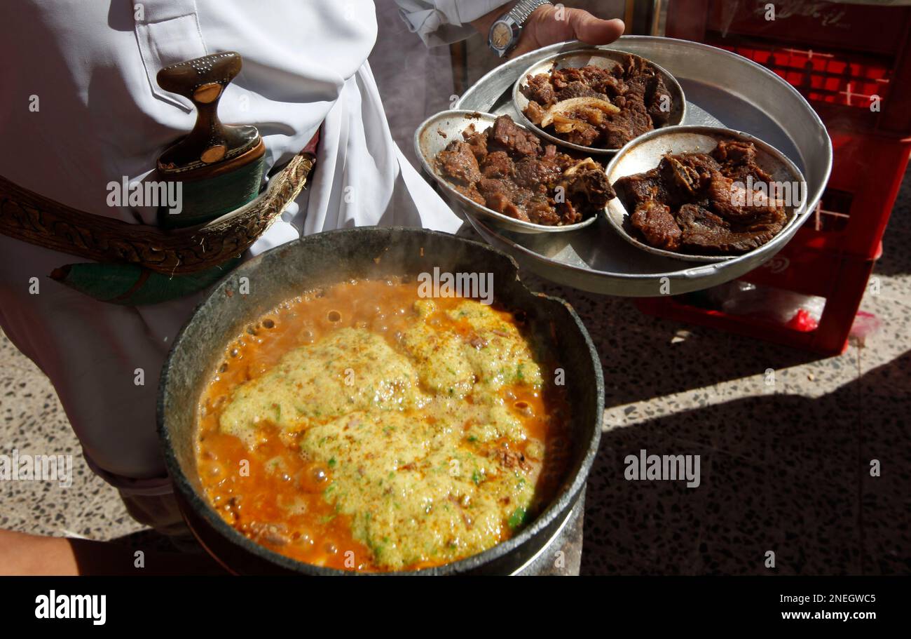 Yemeni restaurant workers serve two traditional Yemeni dishes Salta and ...