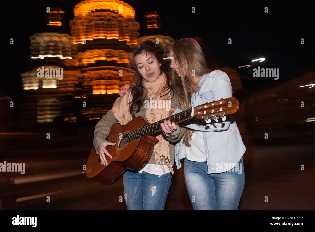 Nightlife girlfriends, girls with a guitar Stock Photo - Alamy