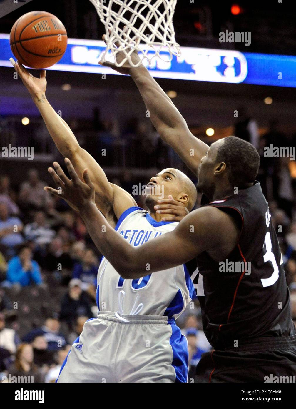Seton Hall's Jordan Theodore, left, goes up with a shot as he is ...