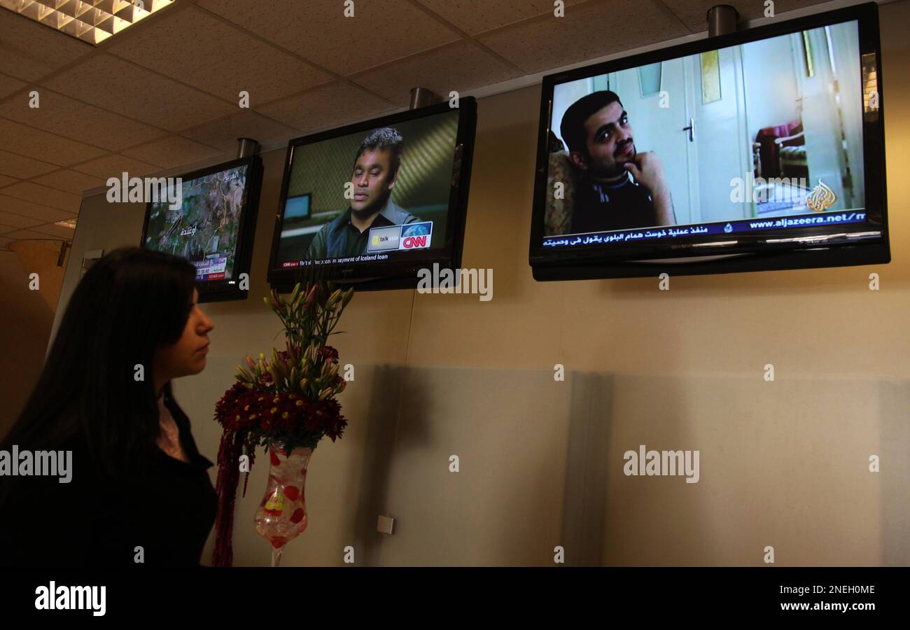 A Jordanian girl watches the Al Jazeera TV station in Jerash, Jordan ...