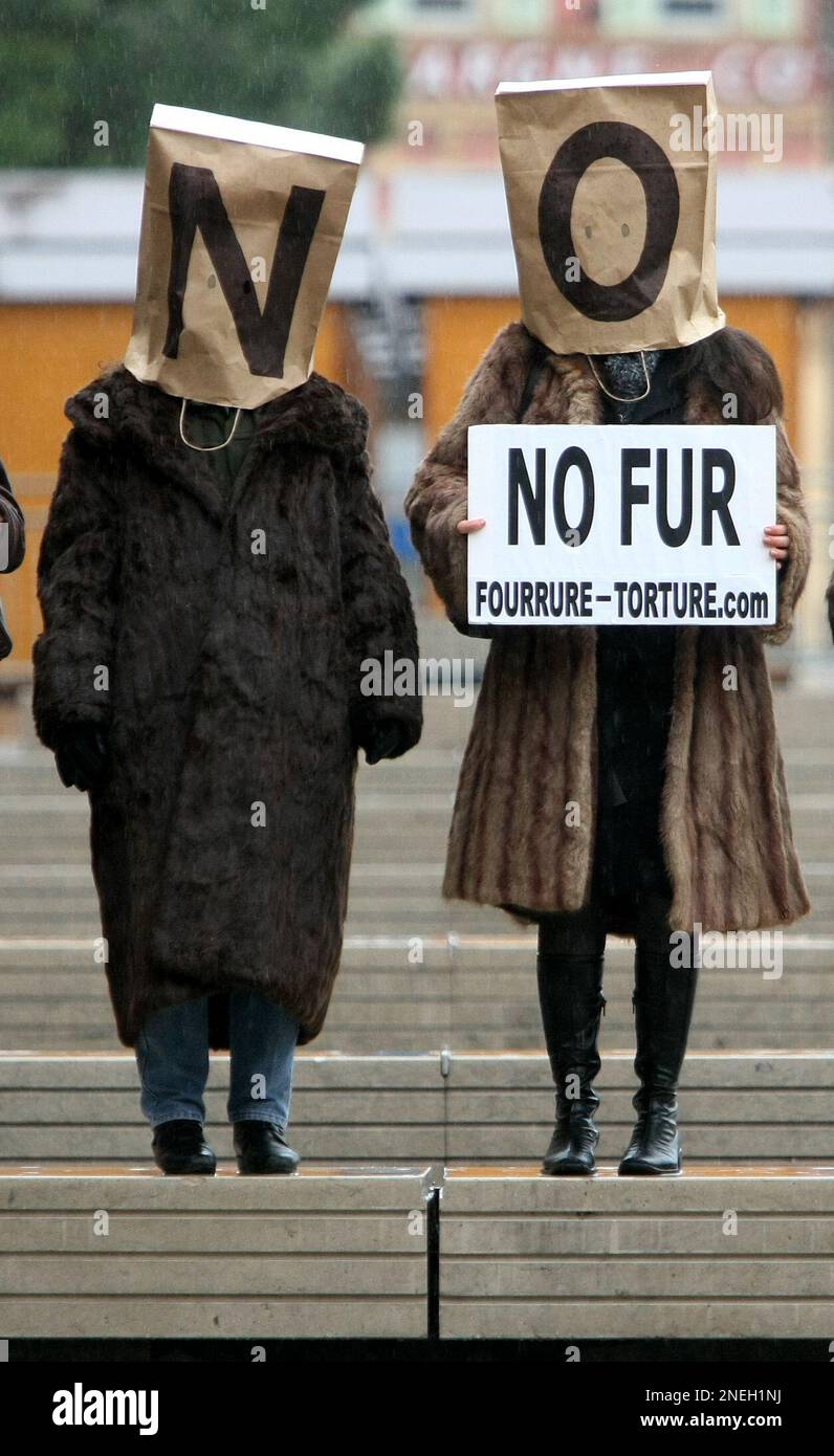 Activists from French anti-fur group "Fur Torture", wear fur coats and ...