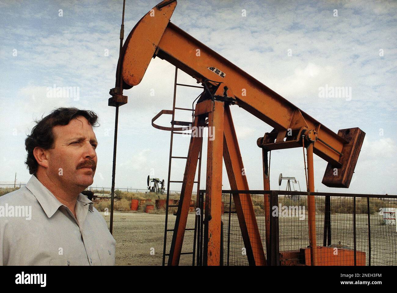 Oil field foreman Darin Holden stands next to one of his company?s oil ...