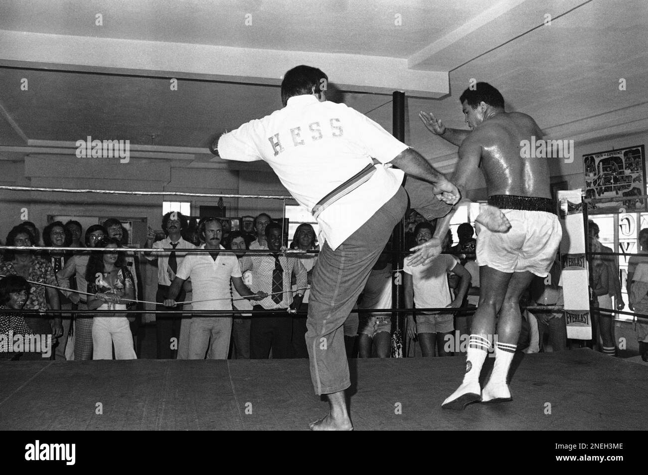 Heavyweight champ Muhammad Ali takes a karate kick in the seat of his pants from heavyweight ...