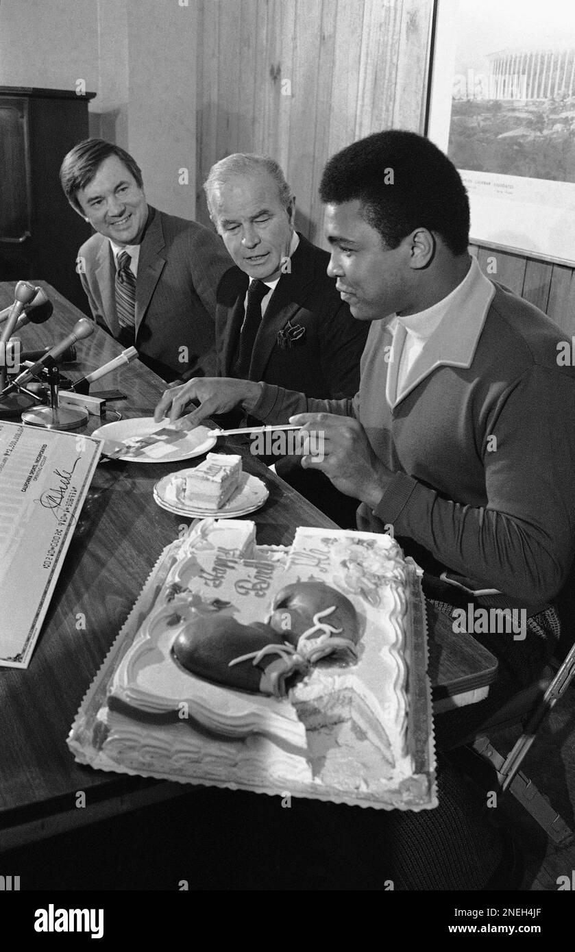 Muhammad Ali, cuts pieces of his birthday cake for Jerry Perenchio ...