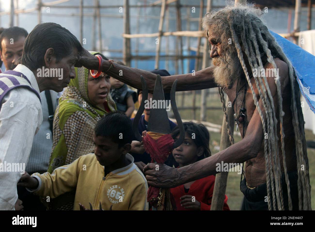 A Nanga Sadhu, or Hindu holy man puts sacred ash on a pilgrim's ...