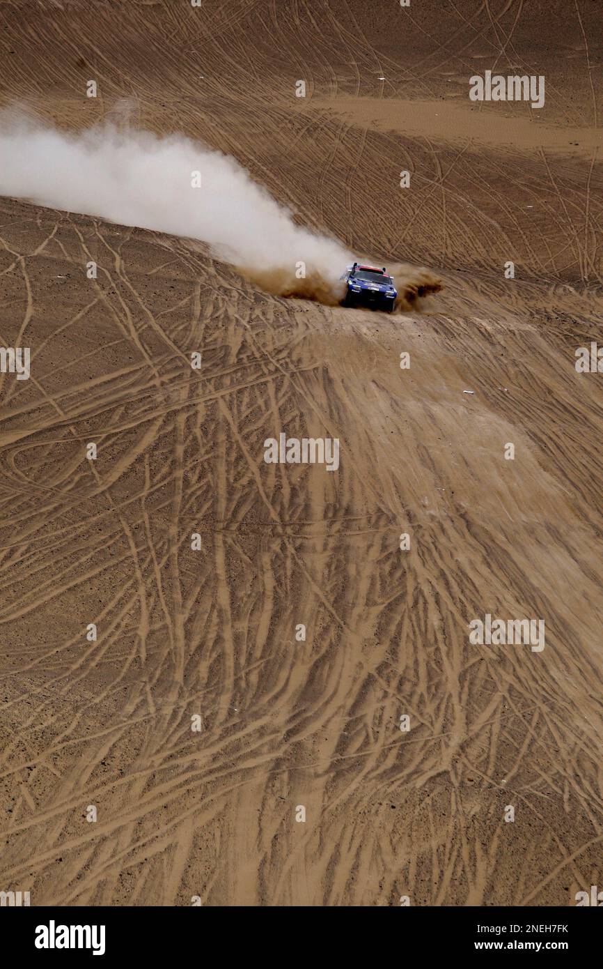 Volkswagen's Mark Miller, of the US, and co-driver Ralph Pitchford, of ...