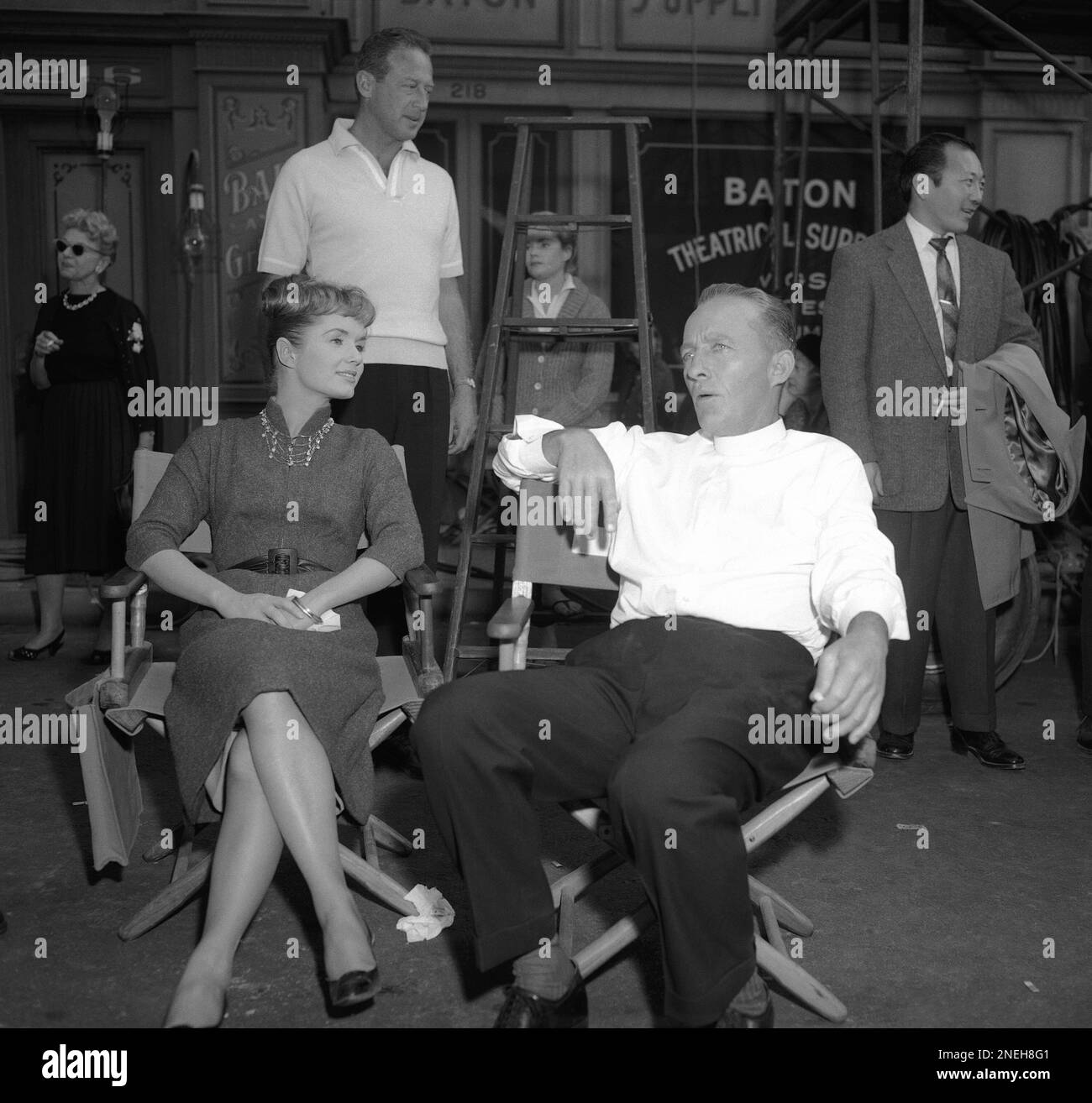 Relaxing between scenes, Bing Crosby talks with Debbie Reynolds on the ...