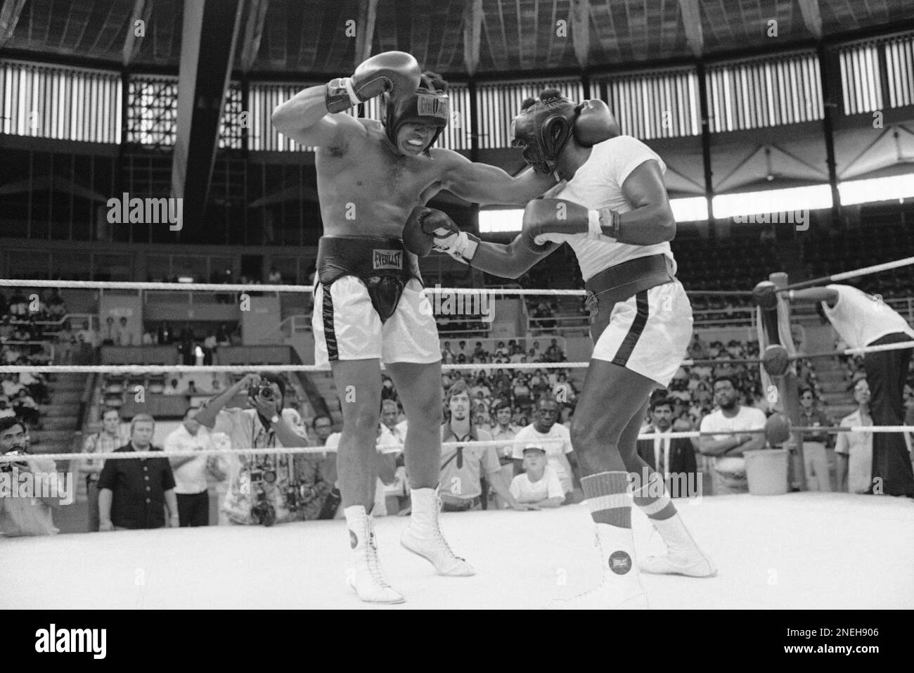 Sparring partner Levi Forte connects with a right to the mid-section of Muhammad Ali as the ...