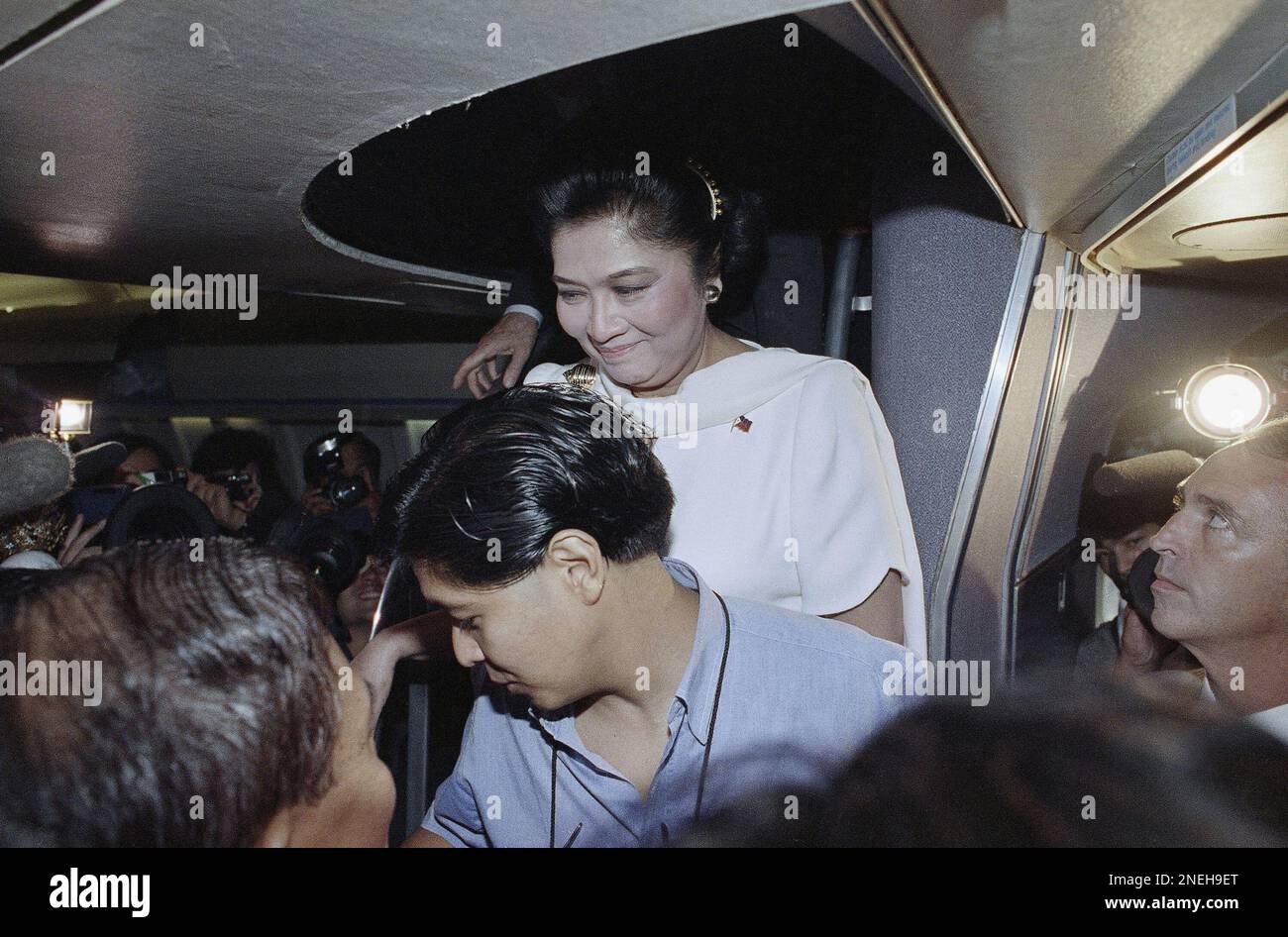 Former Philippine first lady Imelda Marcos is escorted by her son ...