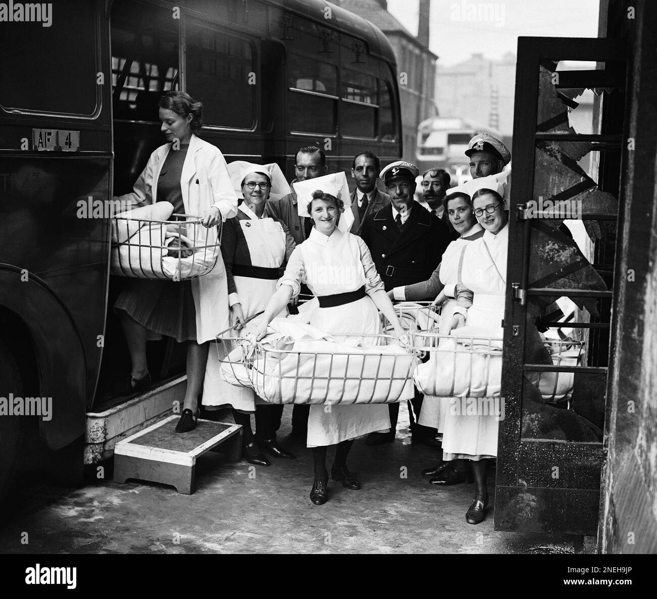 Nurses carrying cribs containing newly born babies to ambulances when ...