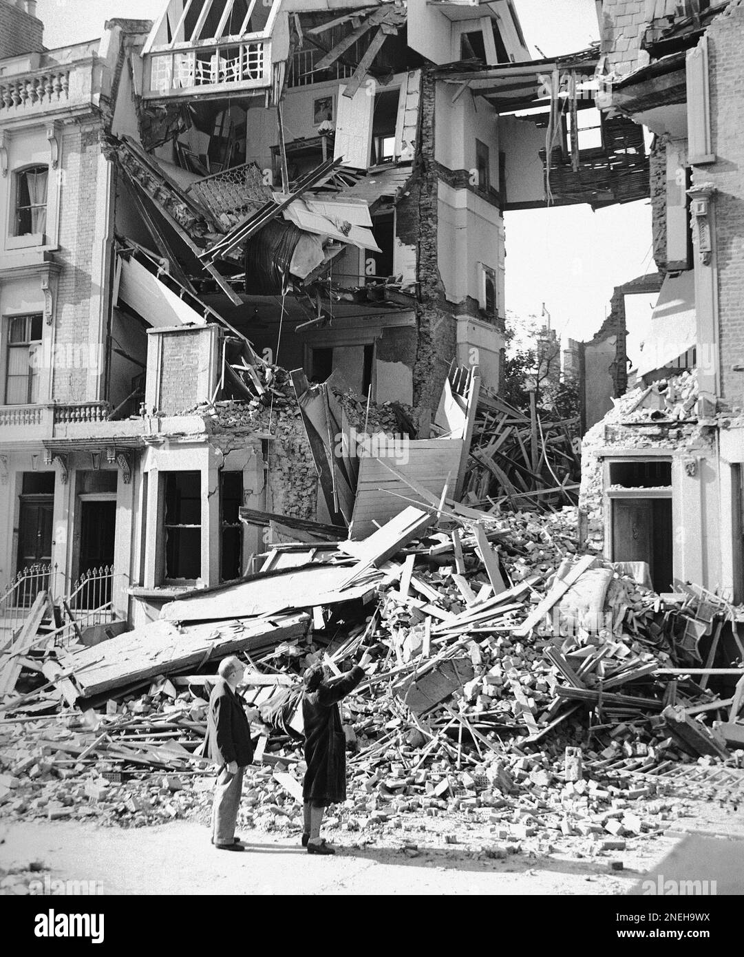 The woman pointing to the damaged house in this picture was buried ...