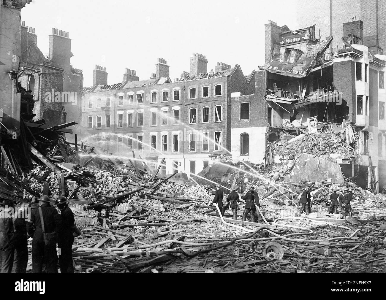 Fire fighters at work bring under control fires started by bombs in ...