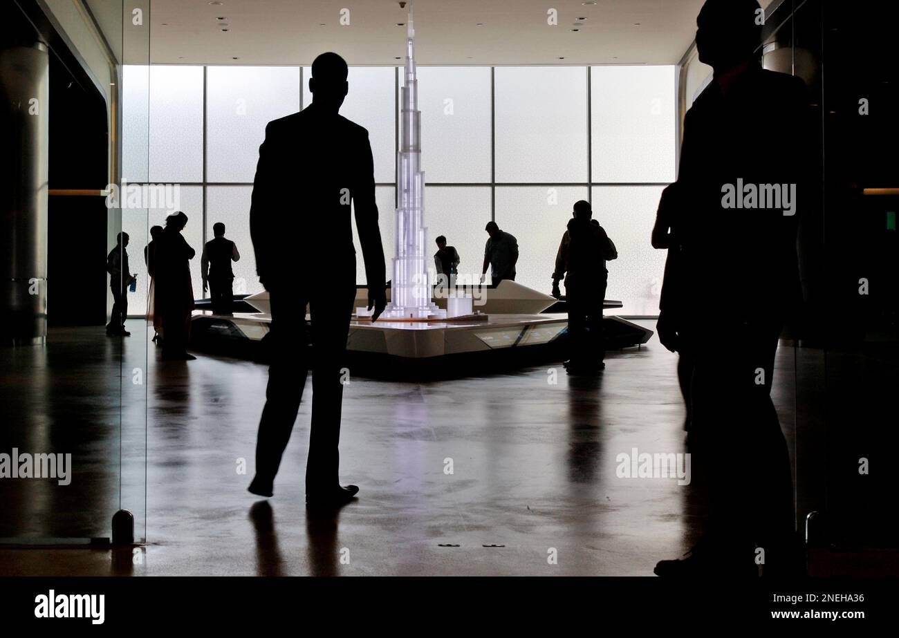 People look at a model of Burj Khalifa , the world's tallest building ...