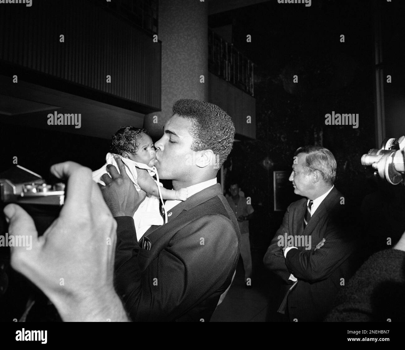 Cassius Clay (Muhammad Ali) kisses 2-month old Claire Marie Wood in the ...