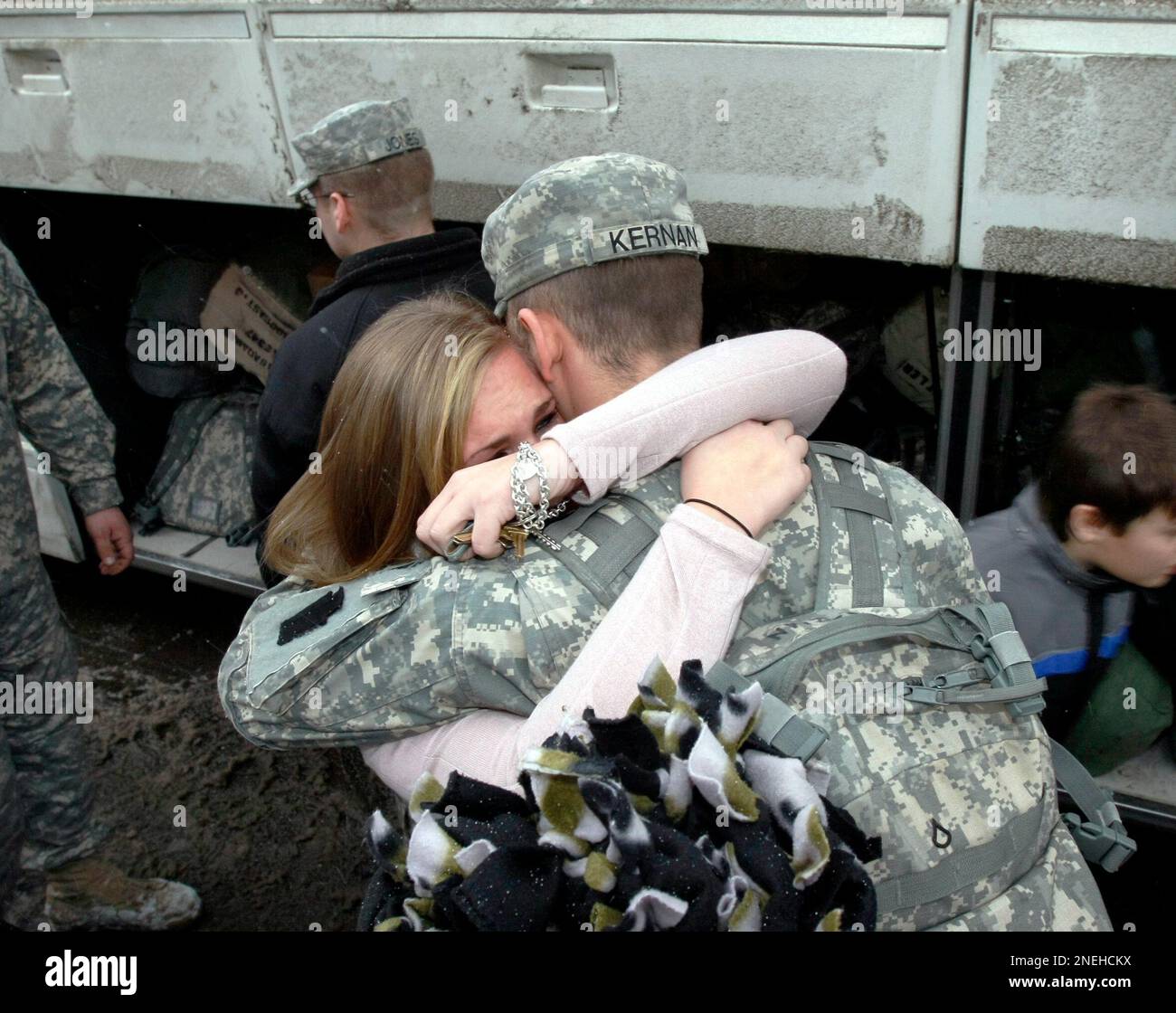 Spc. Daniel Kernan, right, hugs his girlfriend Lauren Meade, as he gets ...