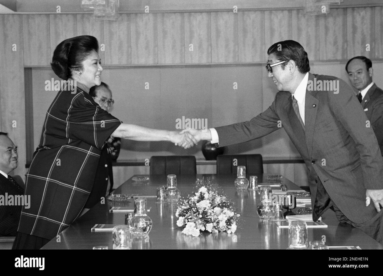 Philippine First Lady Imelda Marcos shakes hands with Japan?s Foreign Minister Shintaro Abe ...