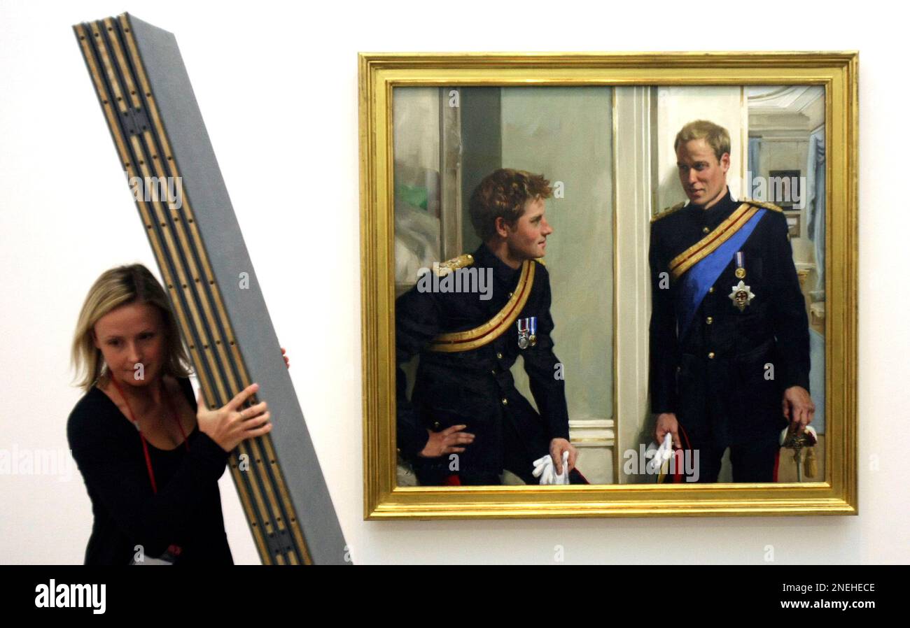 A member of staff removes a screen to unveil a new double portrait by ...