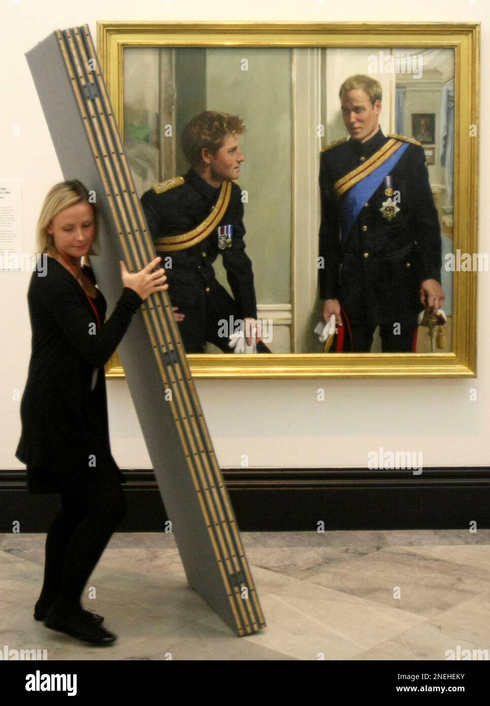 A member of staff removes a screen to unveil a new double portrait by ...
