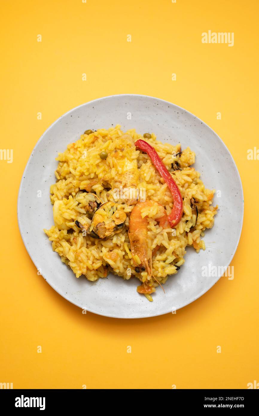 Classic dish of Spain, paella in white plate Stock Photo - Alamy