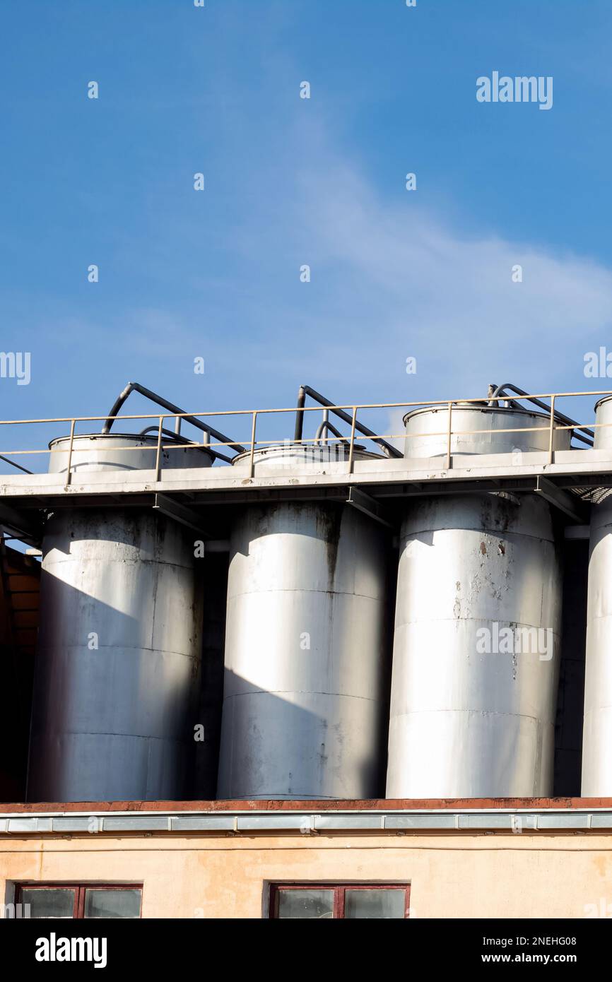 Large metal industrial containers on blue sky background Stock Photo ...