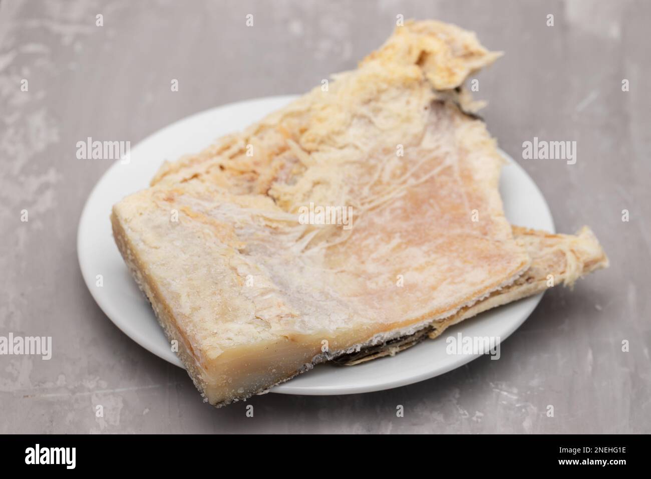 salted cod fish on white small dish on ceramic Stock Photo - Alamy