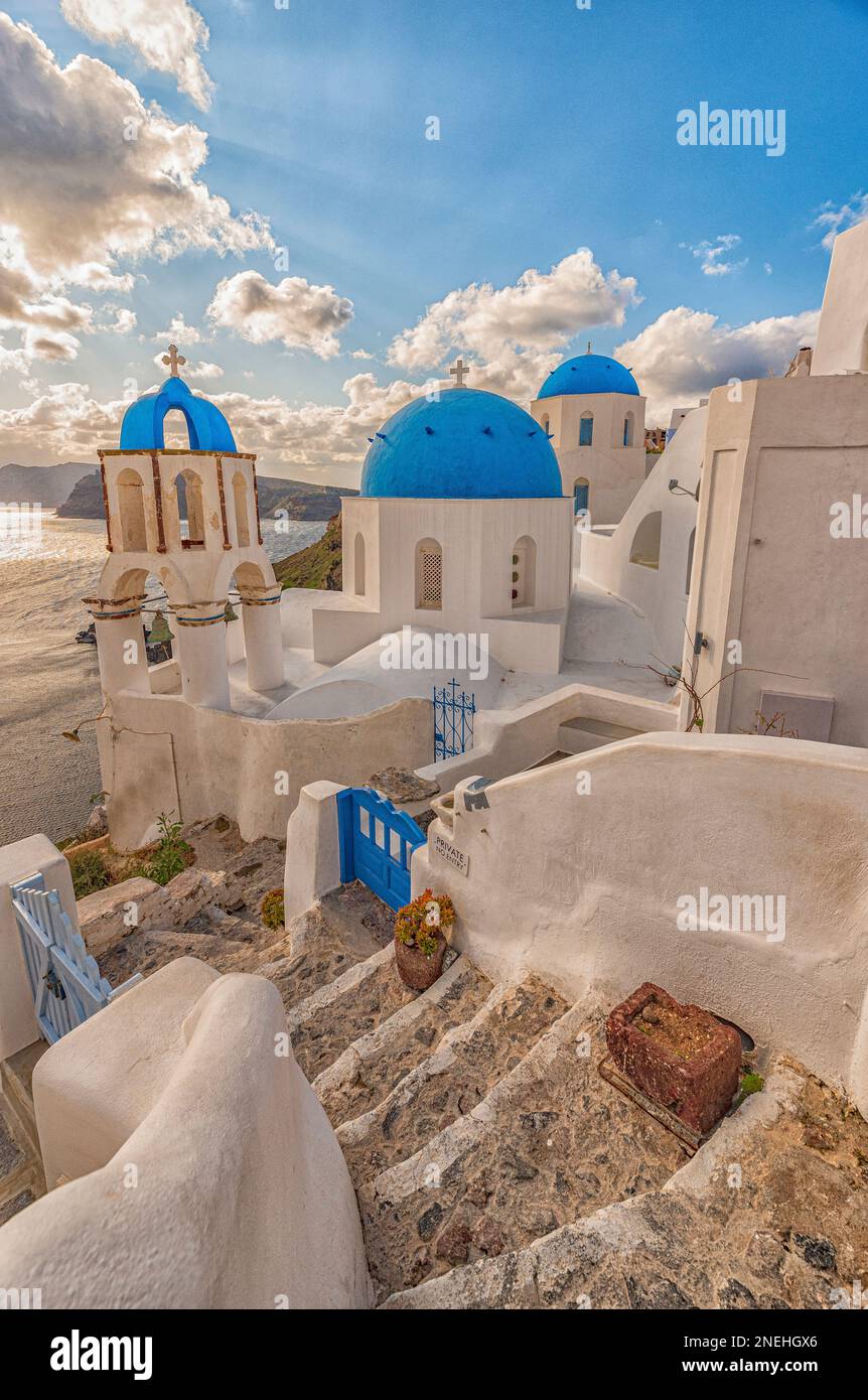 View on the picturesque church with the three blue domes, Santorini ...