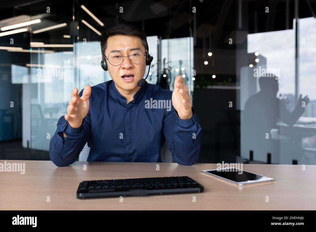 Web camera view, angry man with headset for video call, worker inside ...