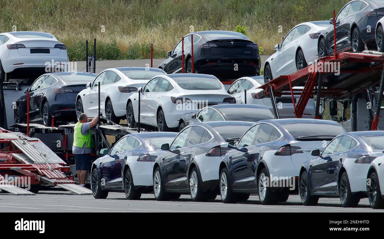 FILE - Tesla cars are loaded onto carriers at the Tesla electric car ...
